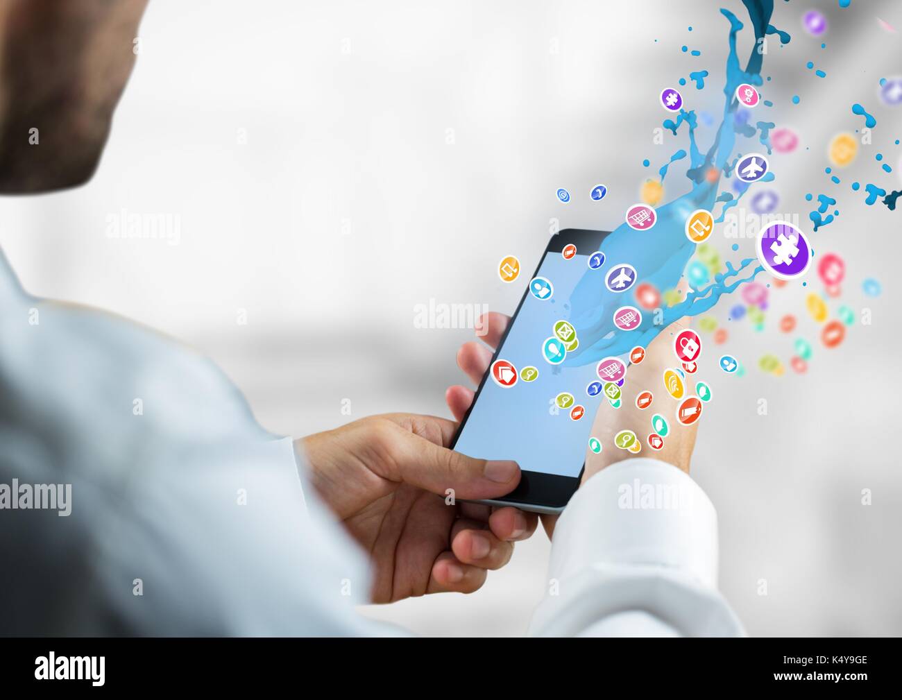 Digital composite of hands with phone with application icons coming up ...