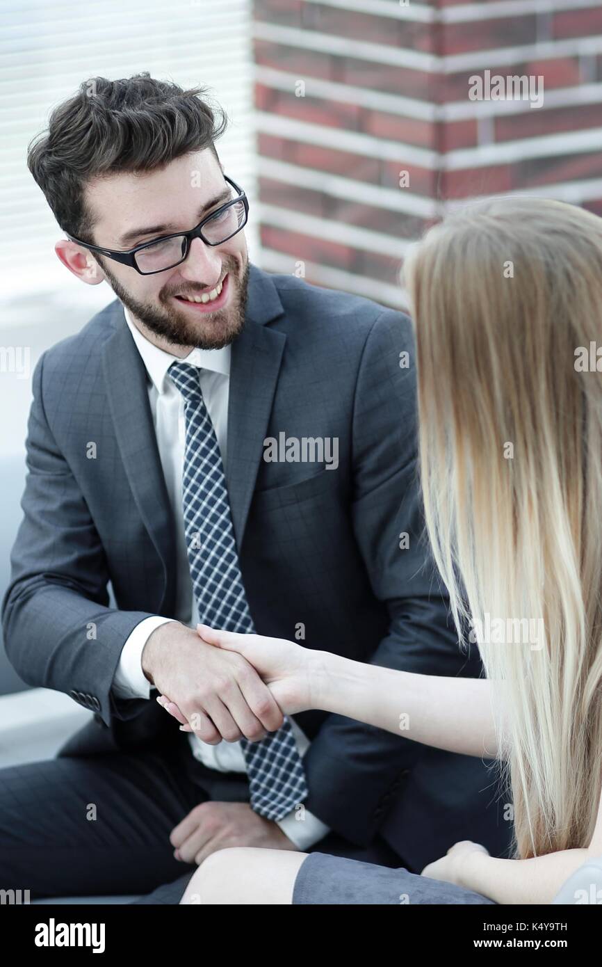 handshake of manager and client sitting in the office lobby Stock Photo ...