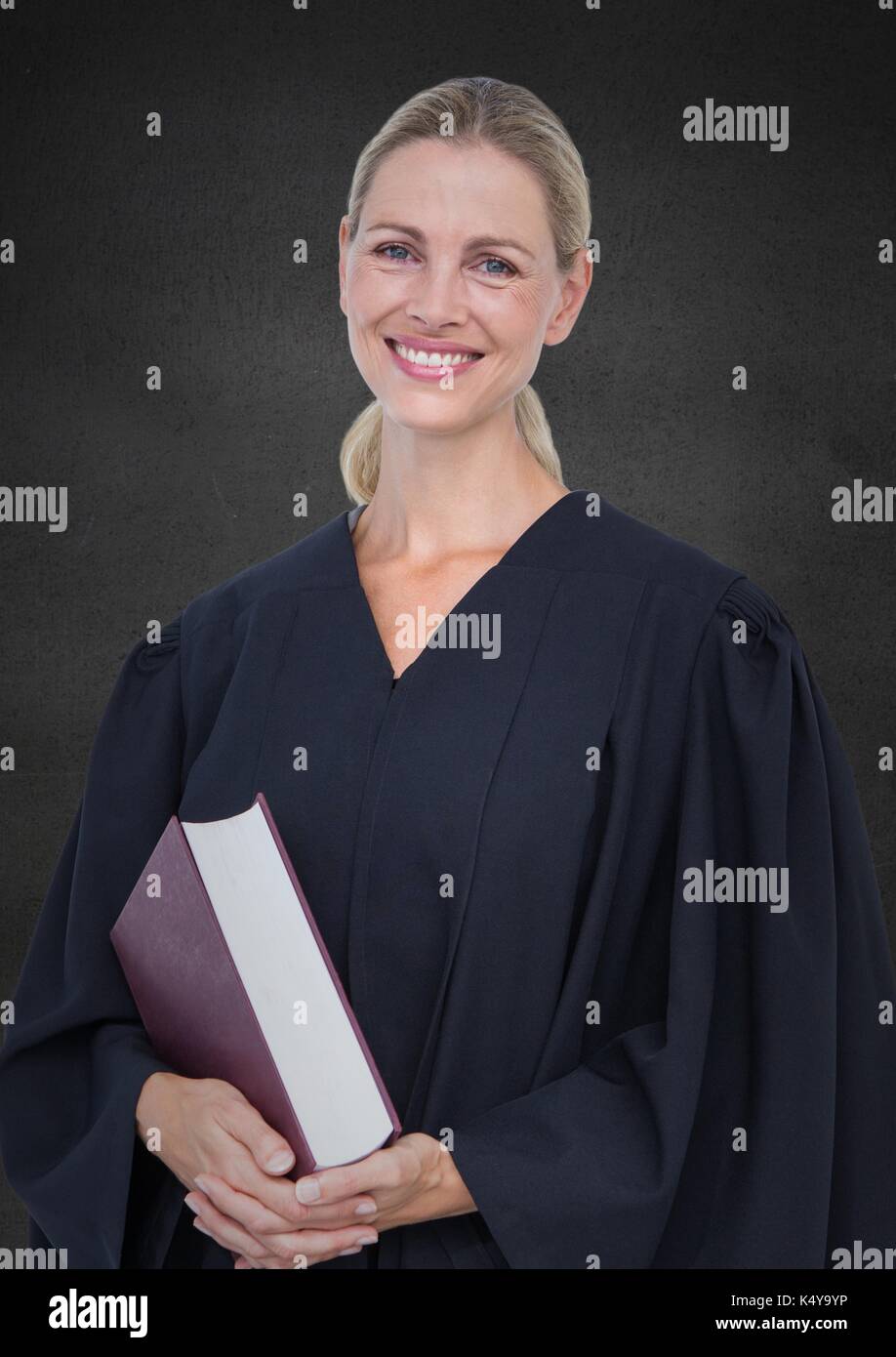 Digital composite of Female judge with book against grey wall Stock ...