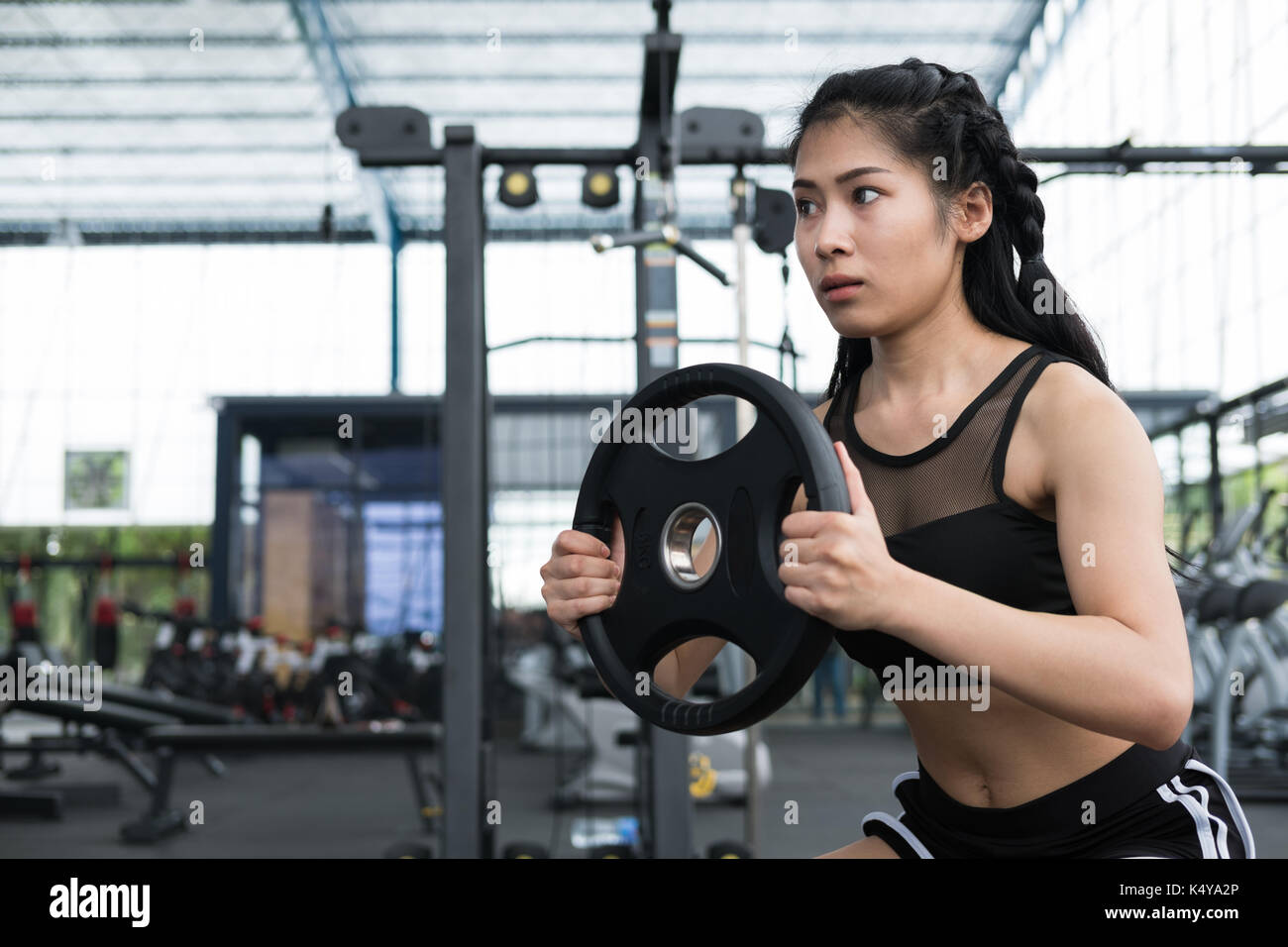 young woman bodybuilder execute exercise in fitness center. female ...