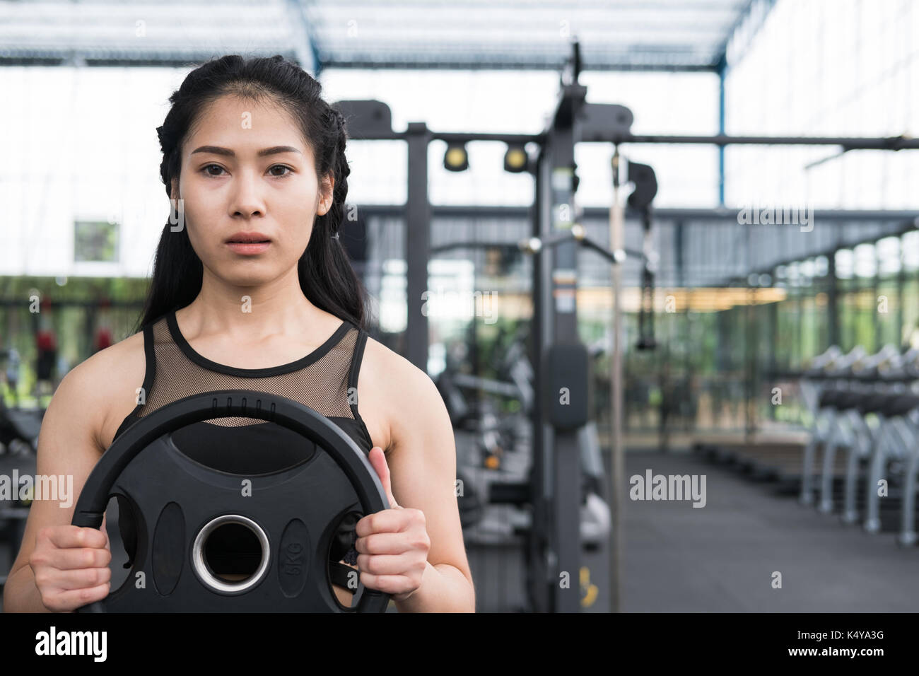 young woman bodybuilder execute exercise in fitness center. female ...