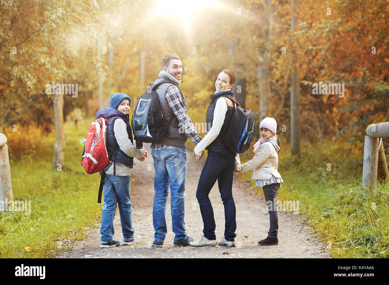 happy family with backpacks hiking walking Stock Photo - Alamy