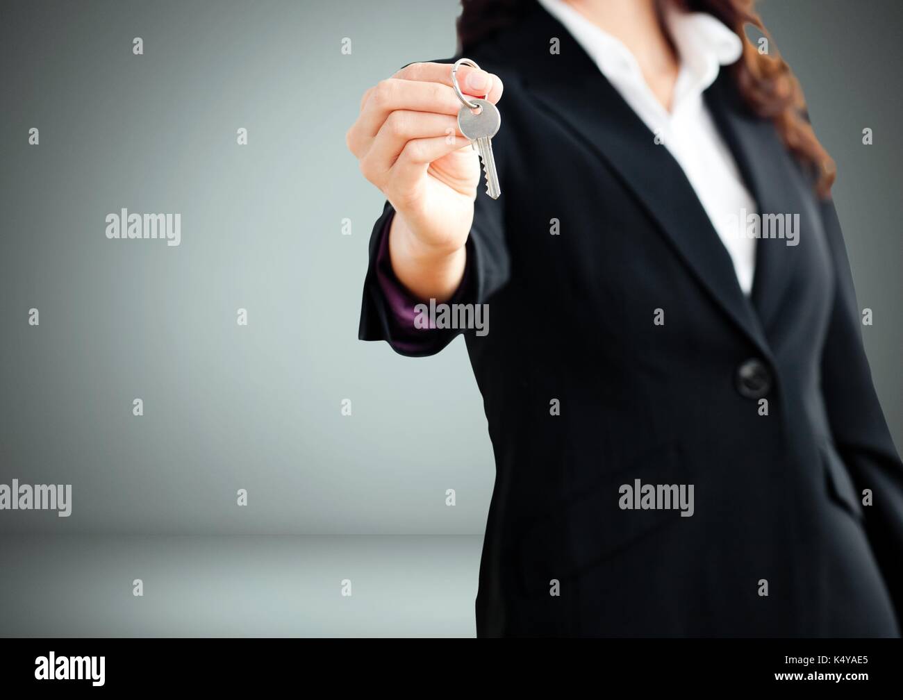 Digital composite of Woman Holding key in front of vignette Stock Photo ...