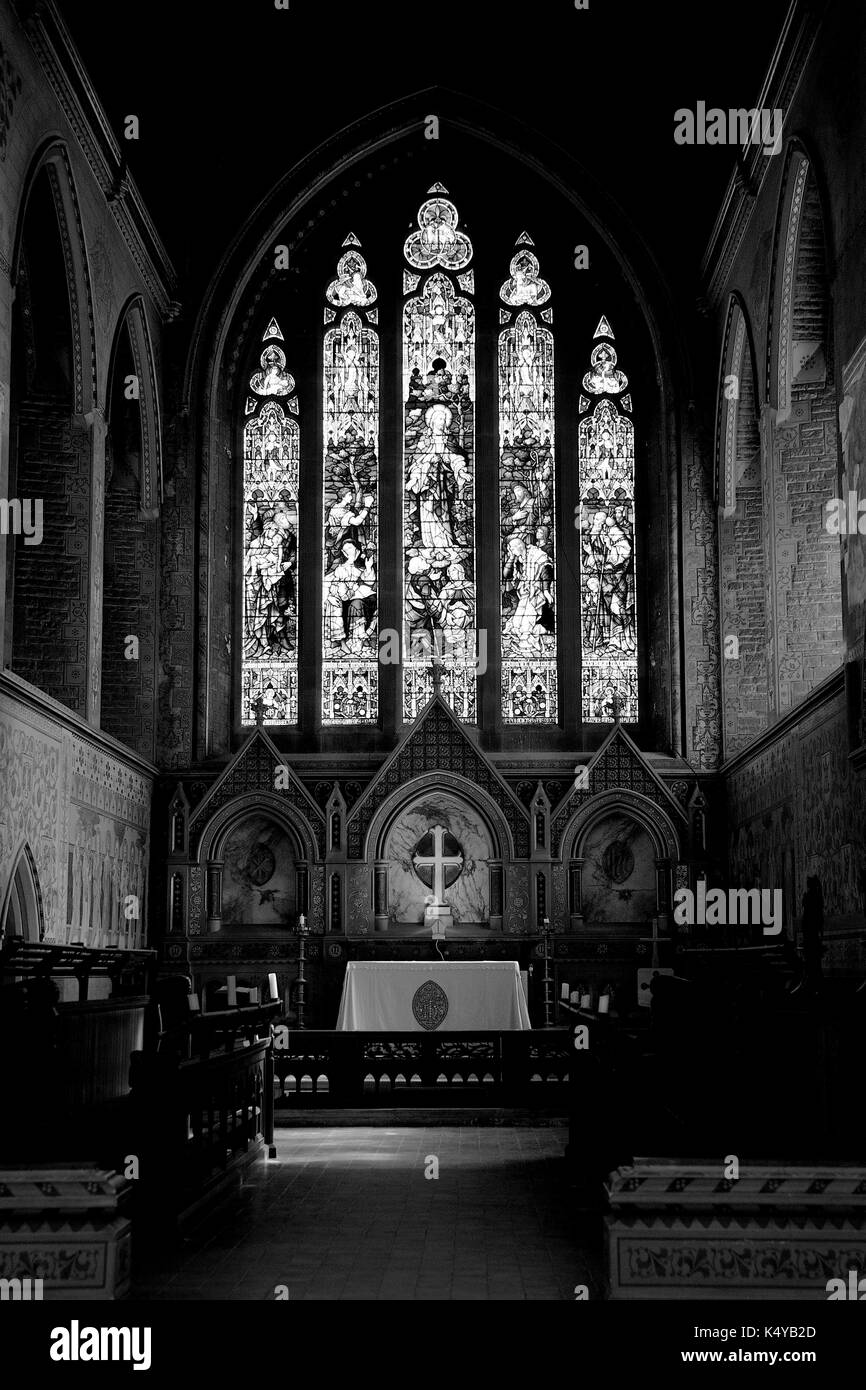 Interior of a church showing main stained glass window and altar Stock ...