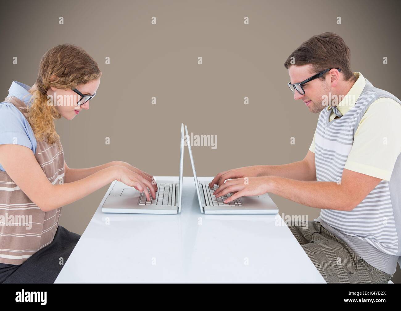 Digital composite of Nerd couple at laptops against brown background ...