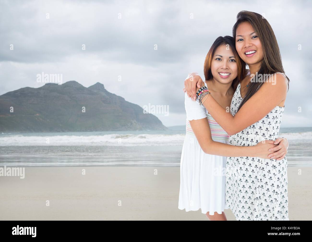 Digital composite of Best friends hugging against blurry beach Stock ...