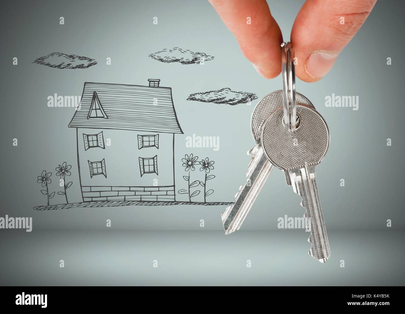 Digital composite of Hand Holding key with house drawing in front of ...