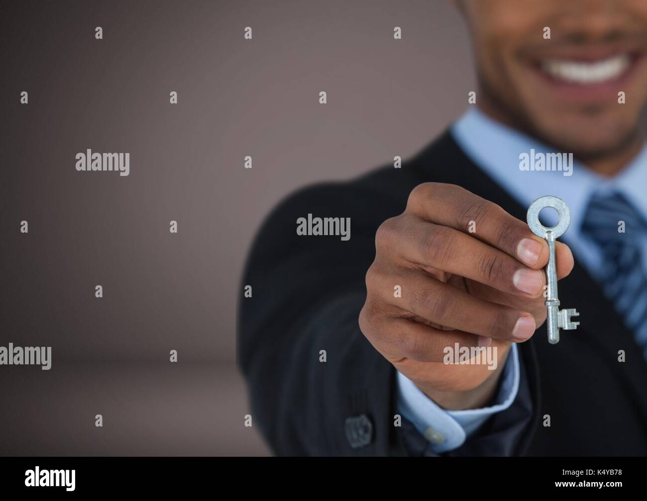 Digital composite of Man holding key in front of Vignette Stock Photo ...