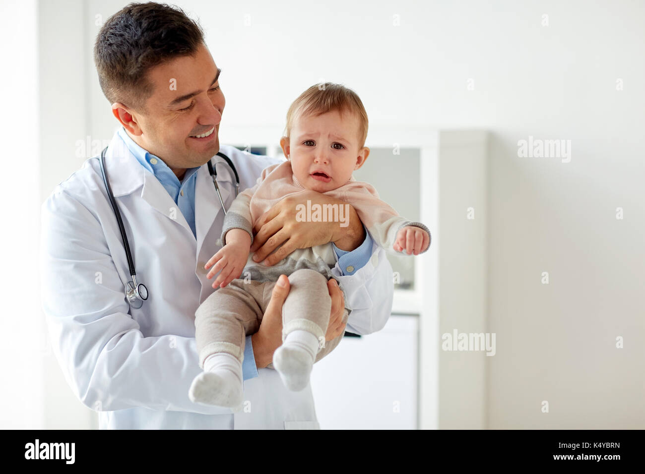happy doctor or pediatrician with baby at clinic Stock Photo - Alamy