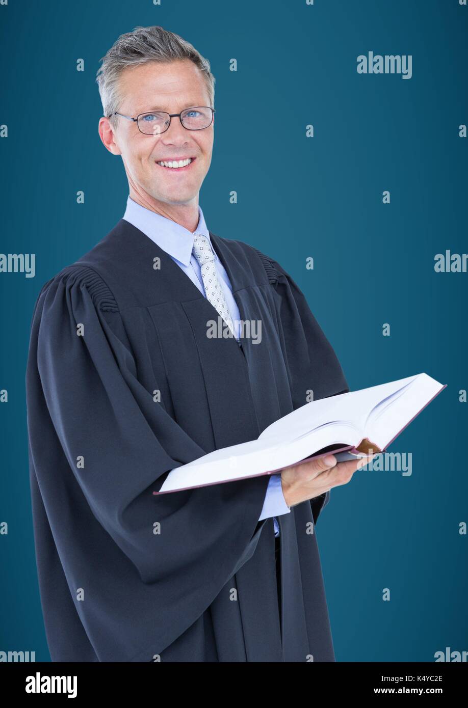 Digital composite of Male judge with open book against blue background ...