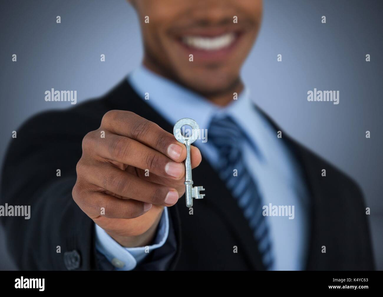 Digital composite of Man Holding key in front of vignette Stock Photo ...