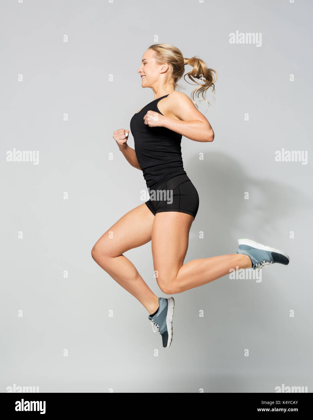 Woman fitness clothes jumping hi-res stock photography and images - Alamy