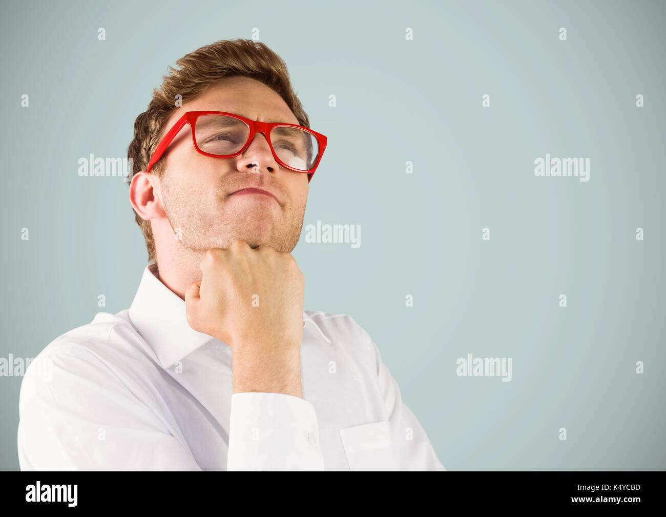 Digital composite of Nerd man thinking against light grey background ...