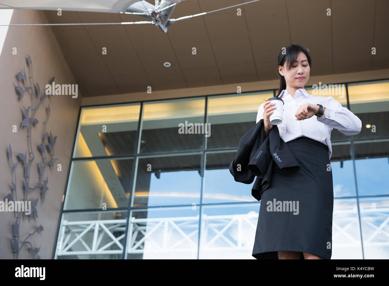 Asian woman checking watch hi-res stock photography and images - Alamy