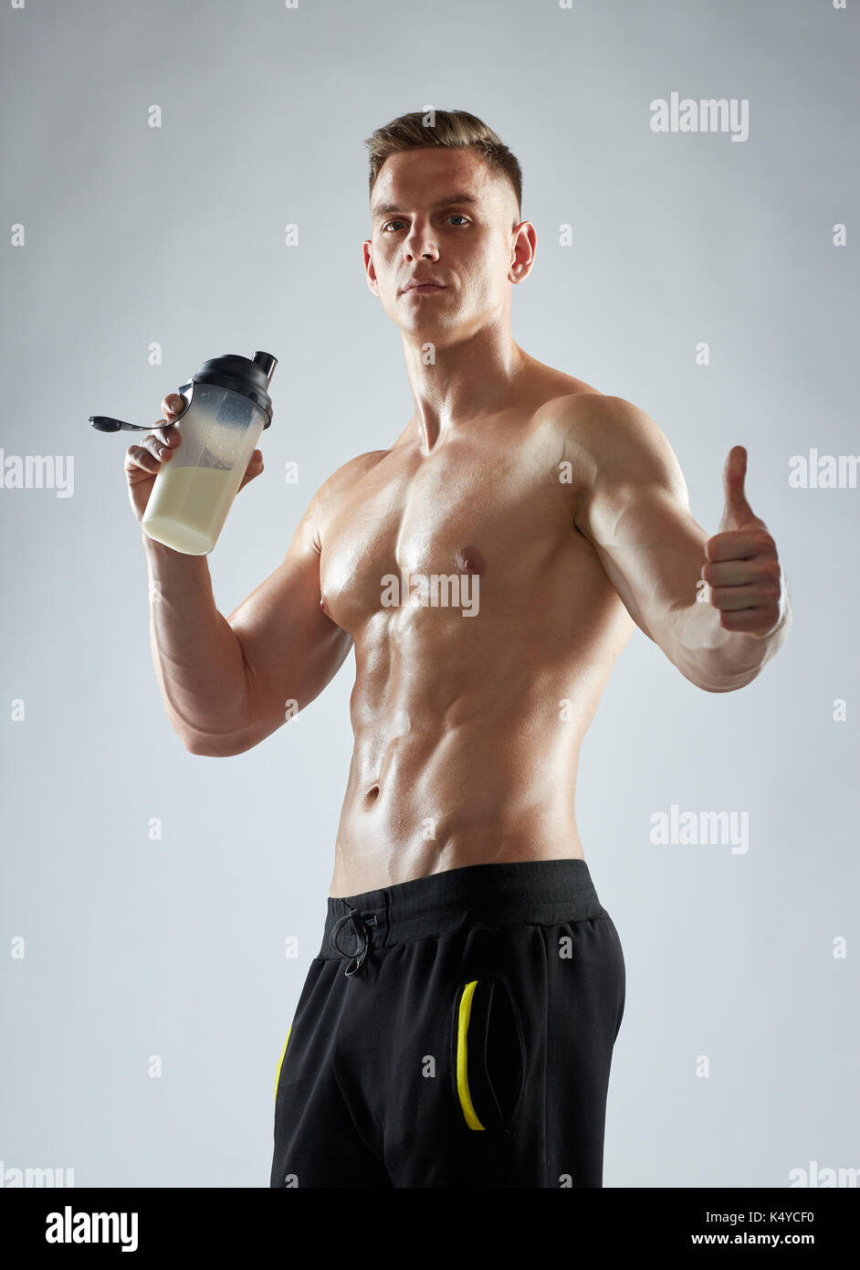 bodybuilder with protein shake showing thumbs up Stock Photo - Alamy