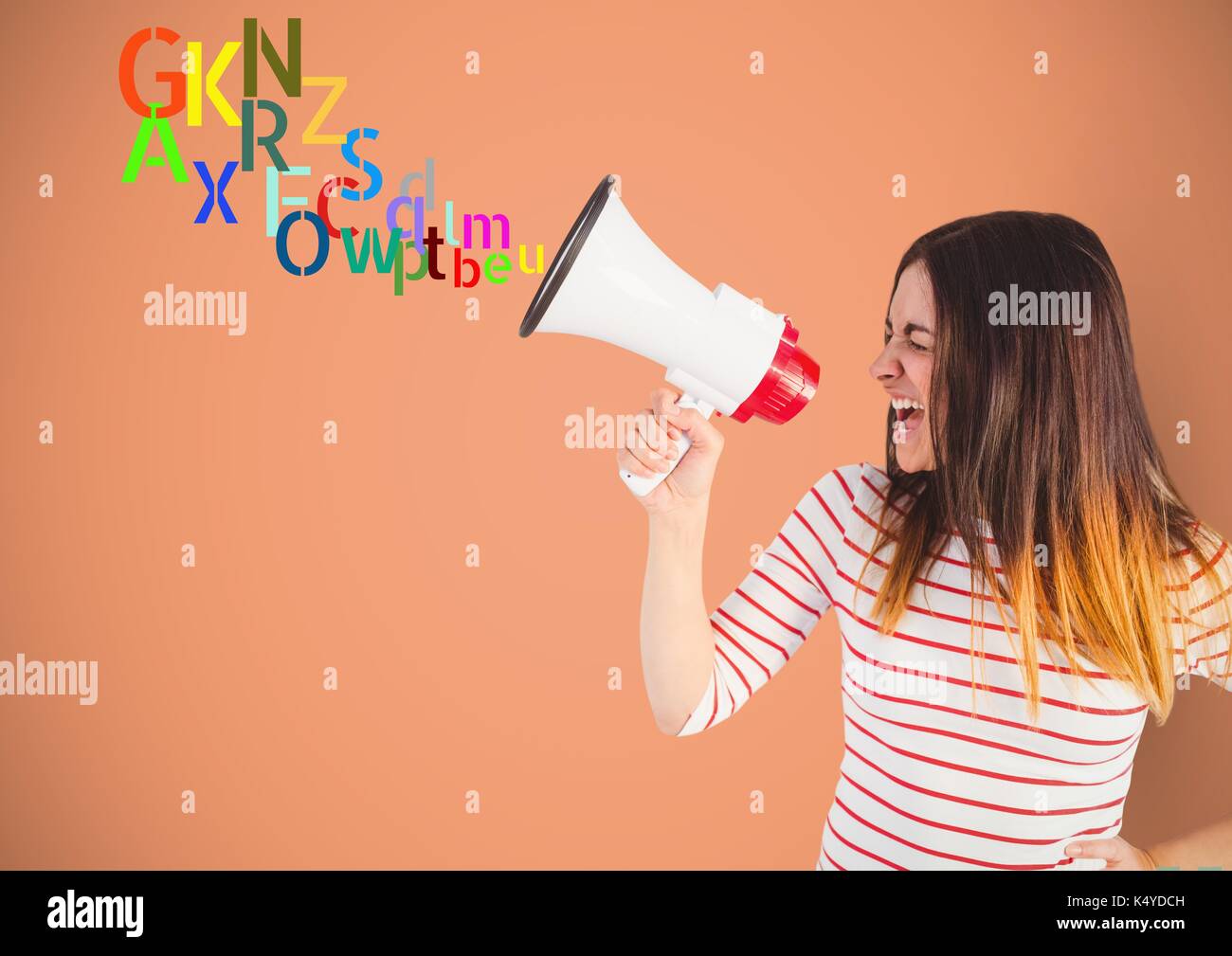 Digital composite of woman shouting by the megaphone with colour ...