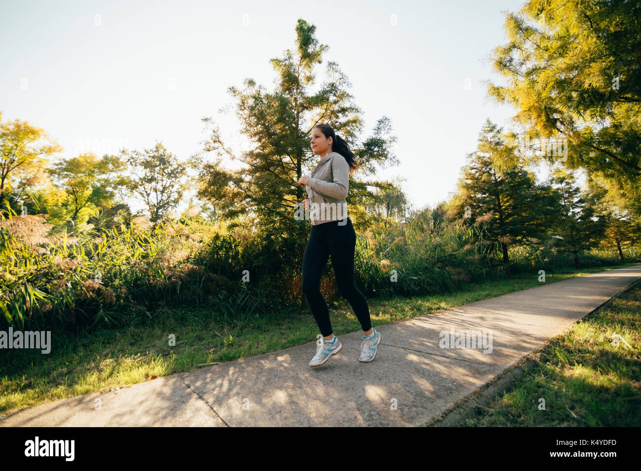 Beautiful woman jogging in nature Stock Photo - Alamy