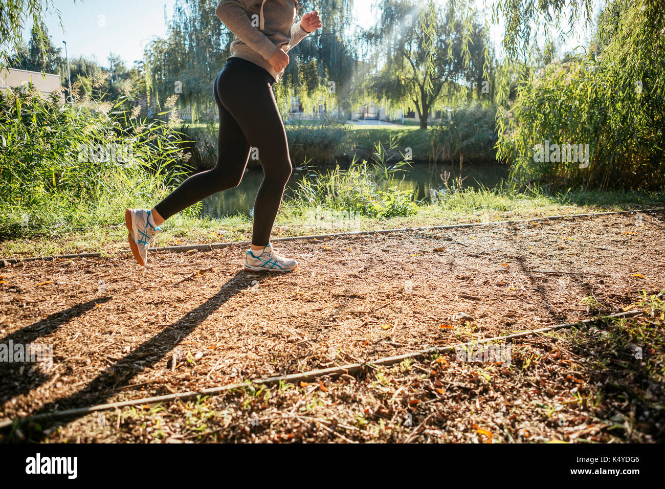 Fit beautiful woman jogging in park Stock Photo - Alamy