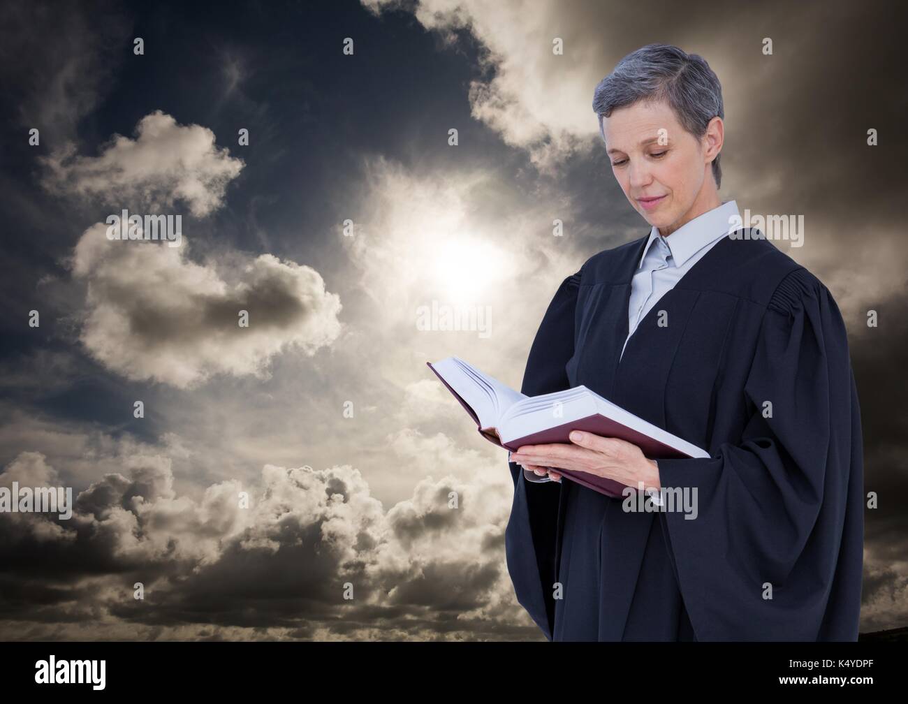 Digital composite of Female judge reading against cloudy sky Stock ...