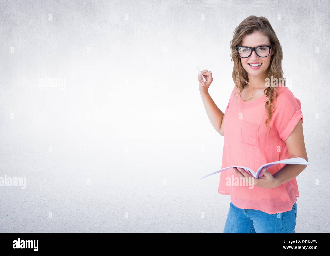 Digital composite of Nerd woman with book writing on white wall Stock ...