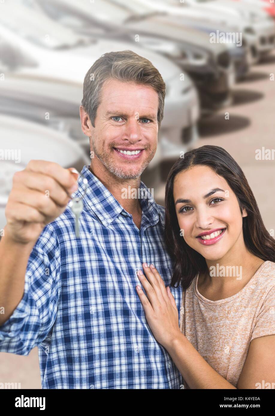 Digital composite of Couple Holding key in front of cars Stock Photo ...