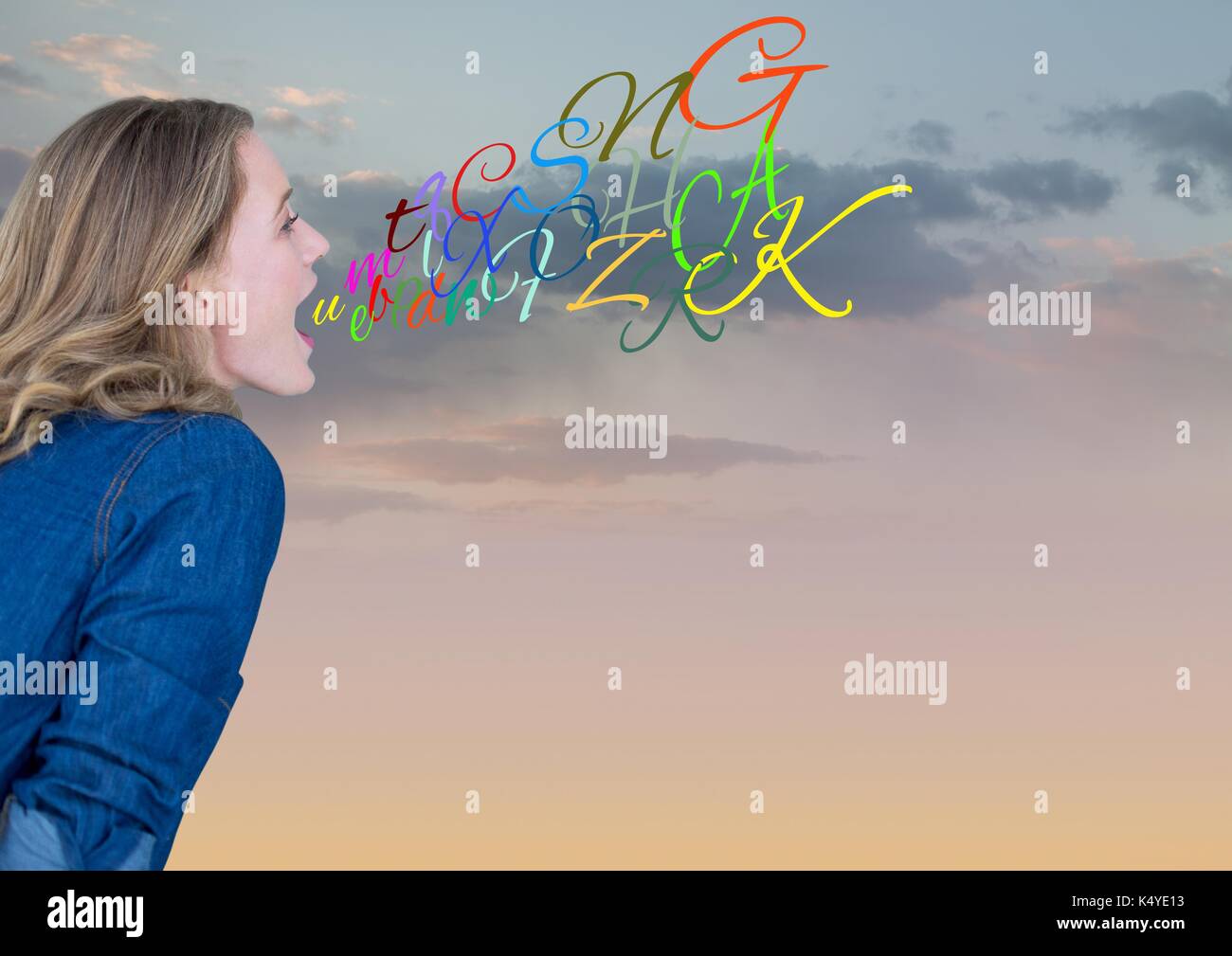 Digital composite of young woman shouting with colour letters coming up ...