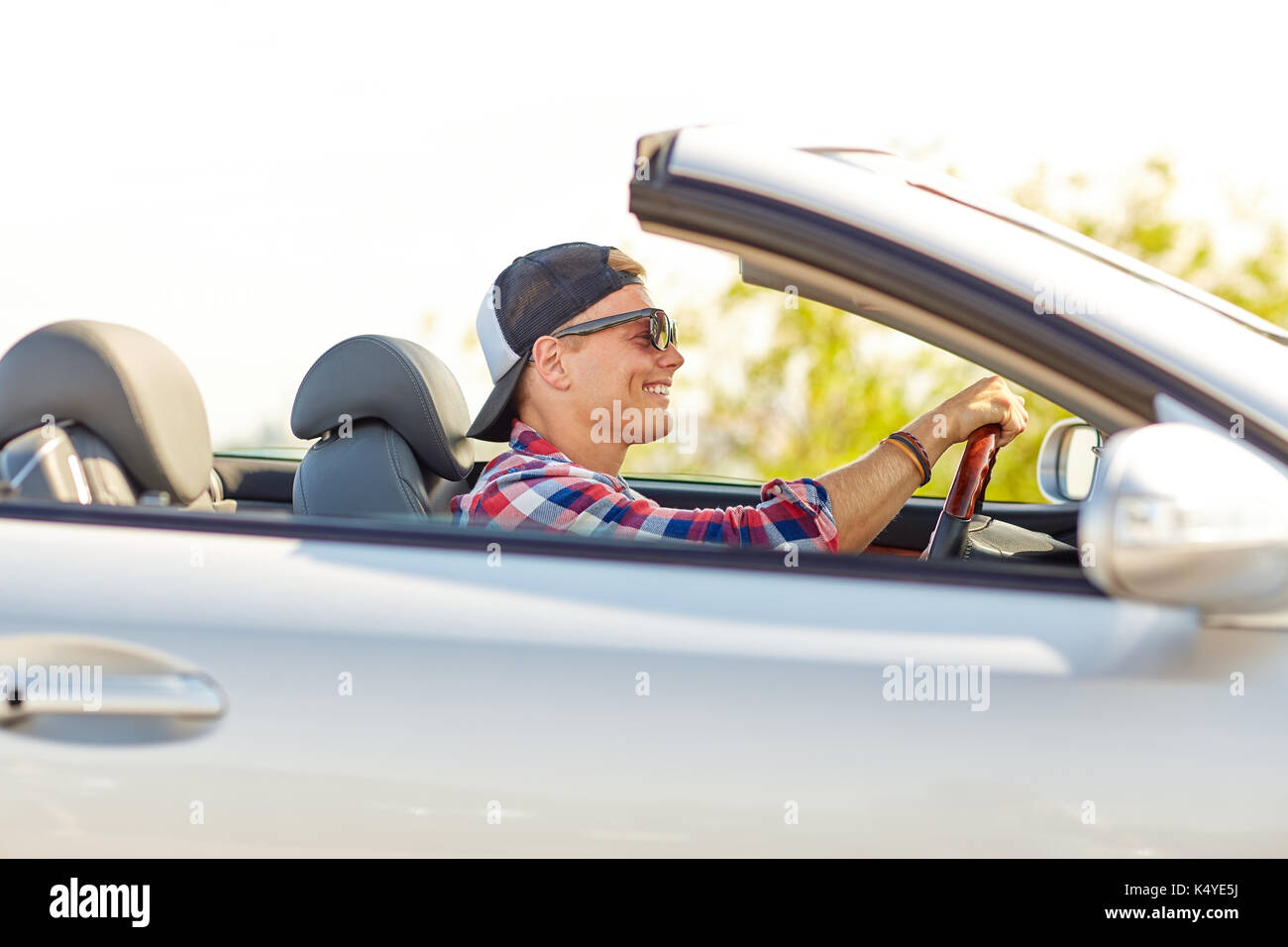 happy young man in shades driving convertible car Stock Photo - Alamy