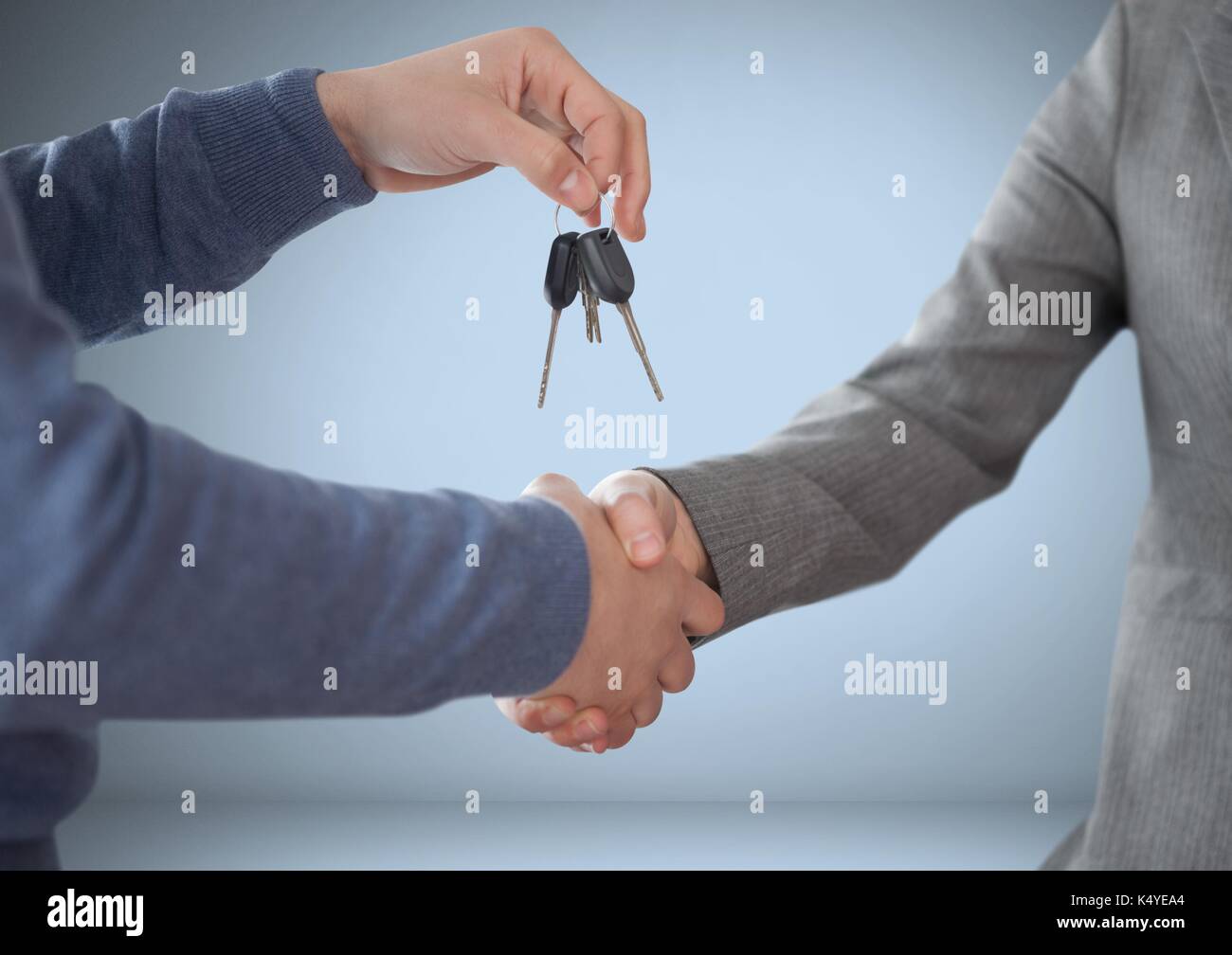Digital composite of Hands Holding key in front of vignette with ...