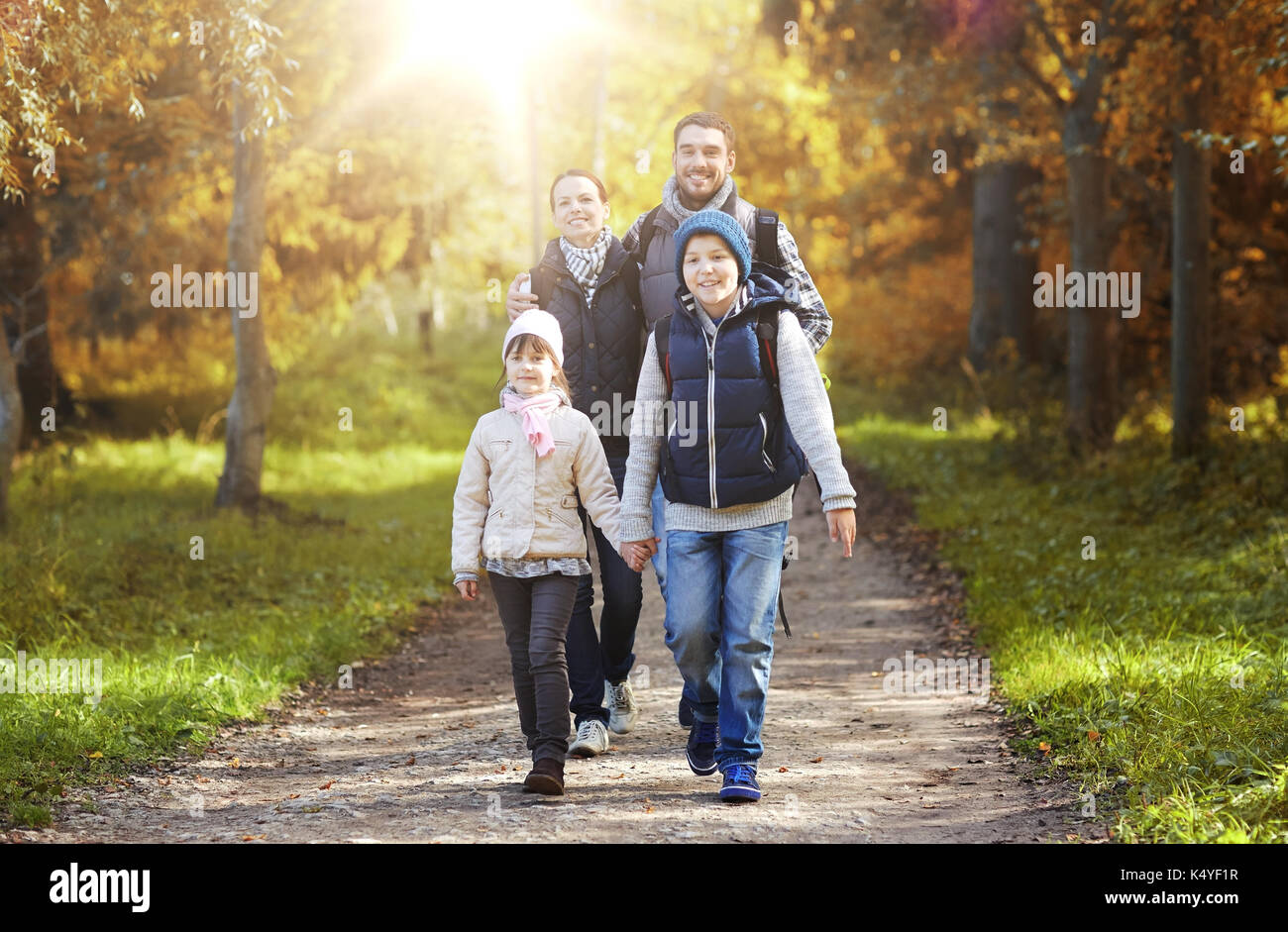happy family with backpacks hiking Stock Photo - Alamy