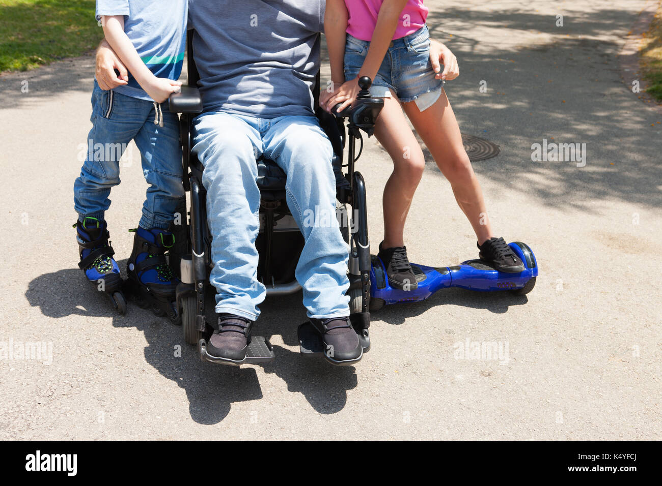 Disabled father on the wheelchair playing with children Stock Photo - Alamy