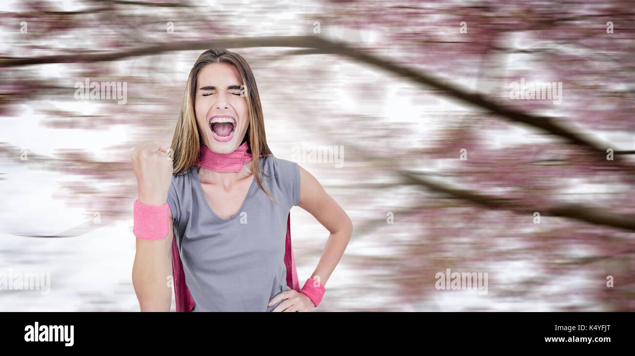 Woman in superhero costume shouting against low angle view of flowering ...