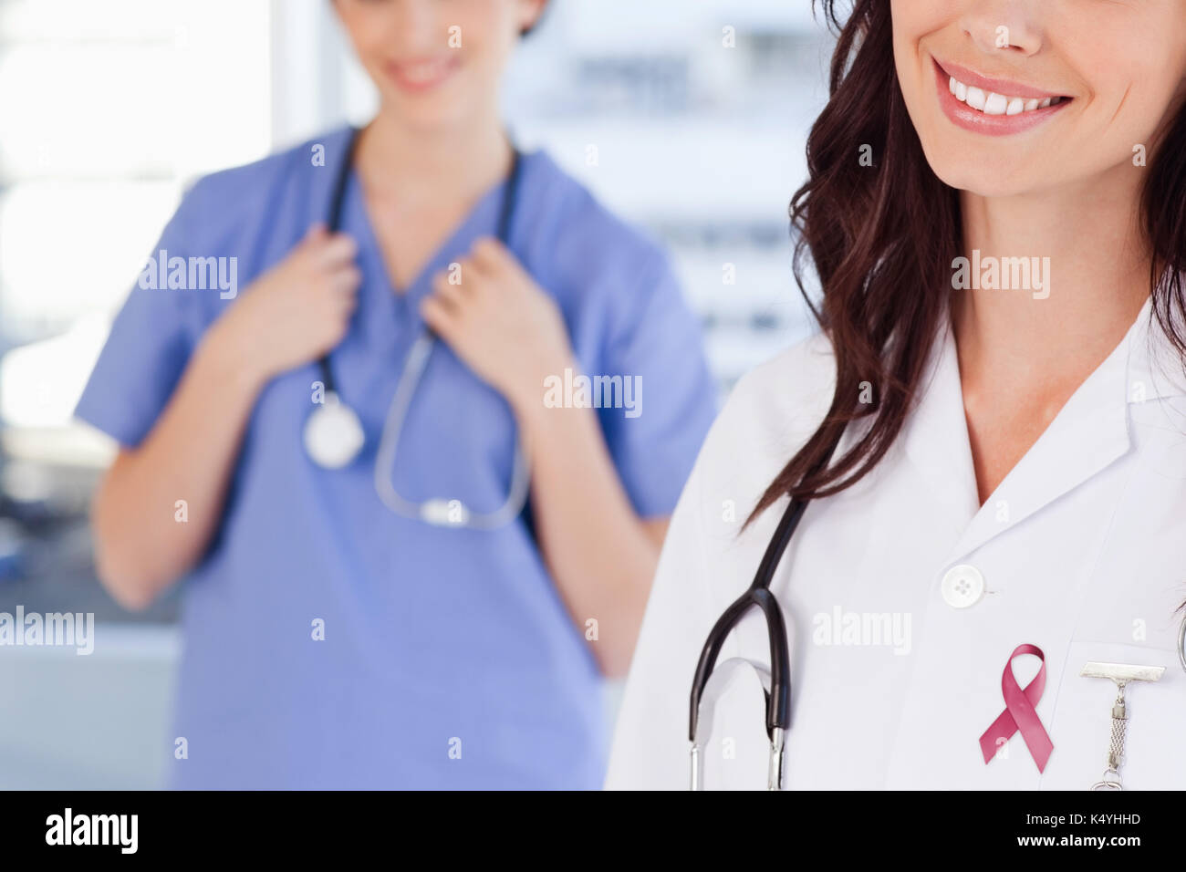 Prostate cancer awareness ribbon against portrait of smiling nurse ...
