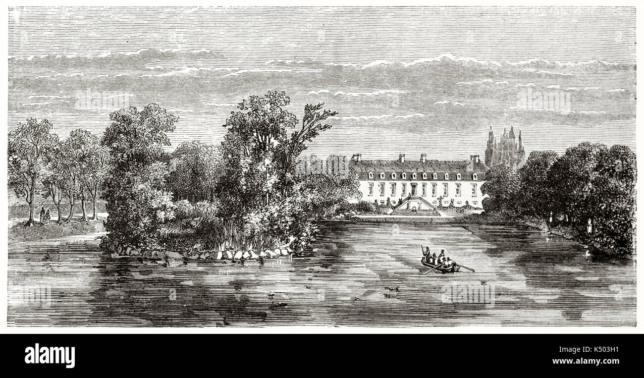Ancient manor house surrounded by thick vegetation and a the water ...