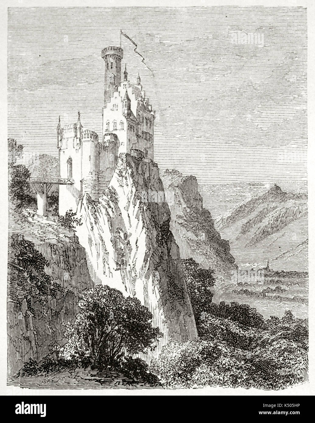 White medieval castle on top of a high peak over the german forest. Old ...