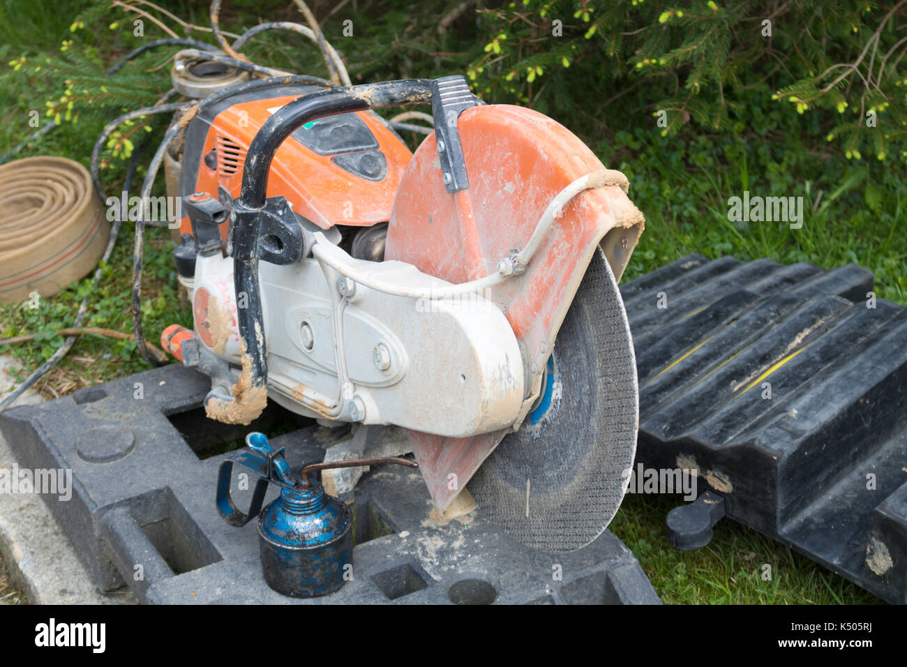 Concrete gasoline saw grinder at construction site Construction workers ...