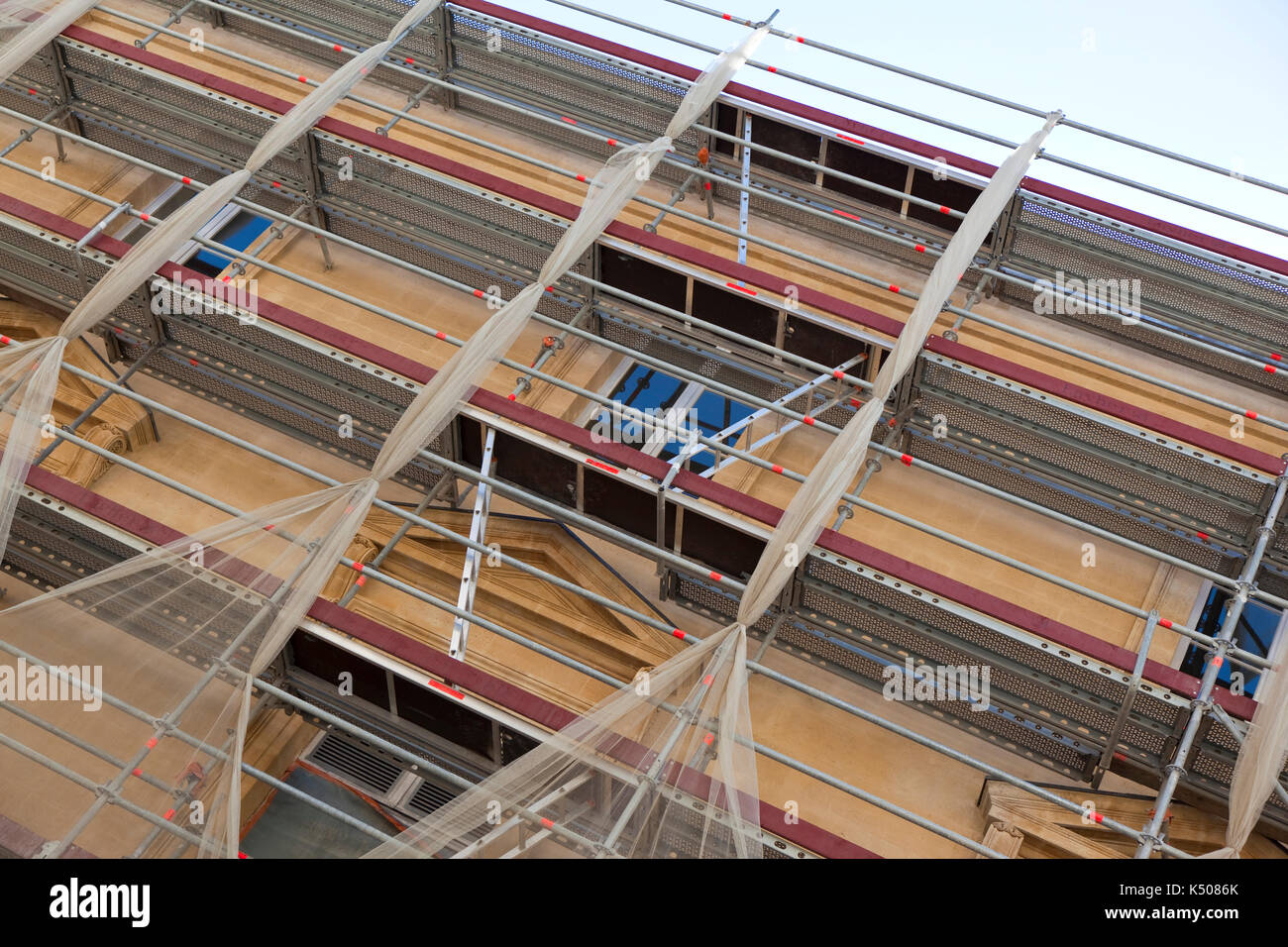 Scaffolding and safety net on the facade of a reovates building Stock ...