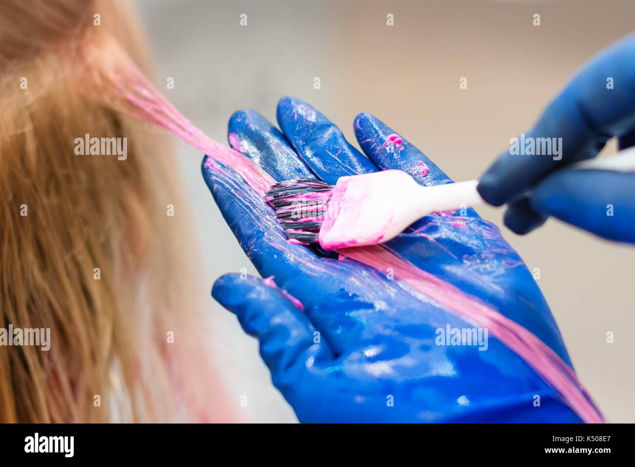 Hairdresser is dying female hair. Hands in glives with brush, coloring ...