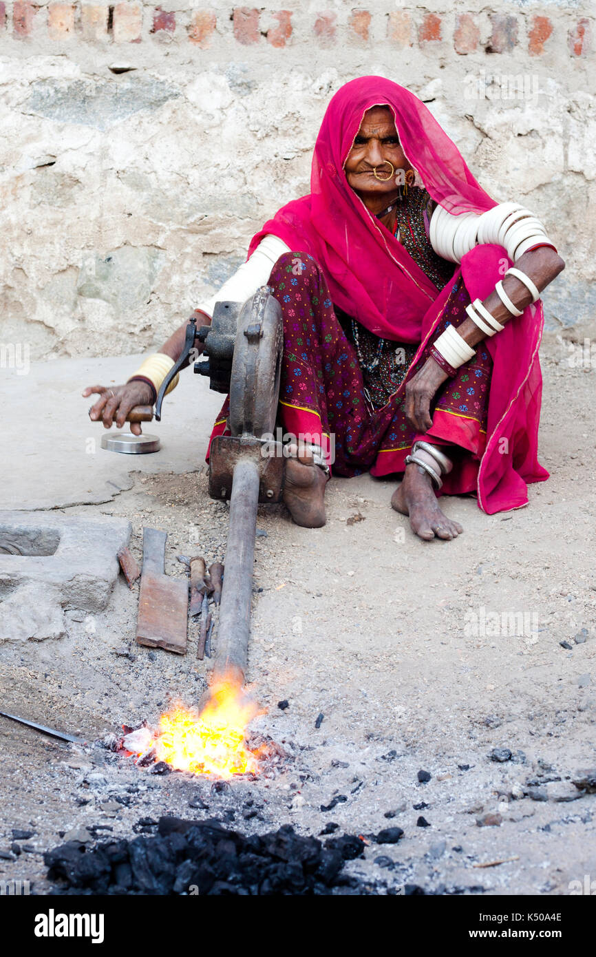 Elderly woman starting a fire Stock Photo - Alamy
