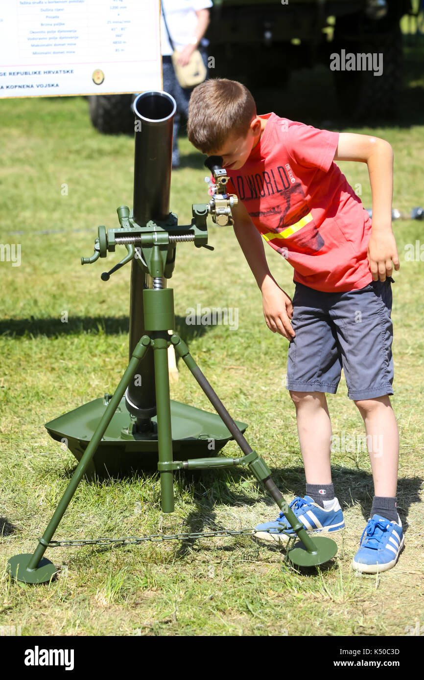 ZAGREB, CROATIA - MAY 28, 2017 : A boy sightseeing mortar 120 mm M 75 ...