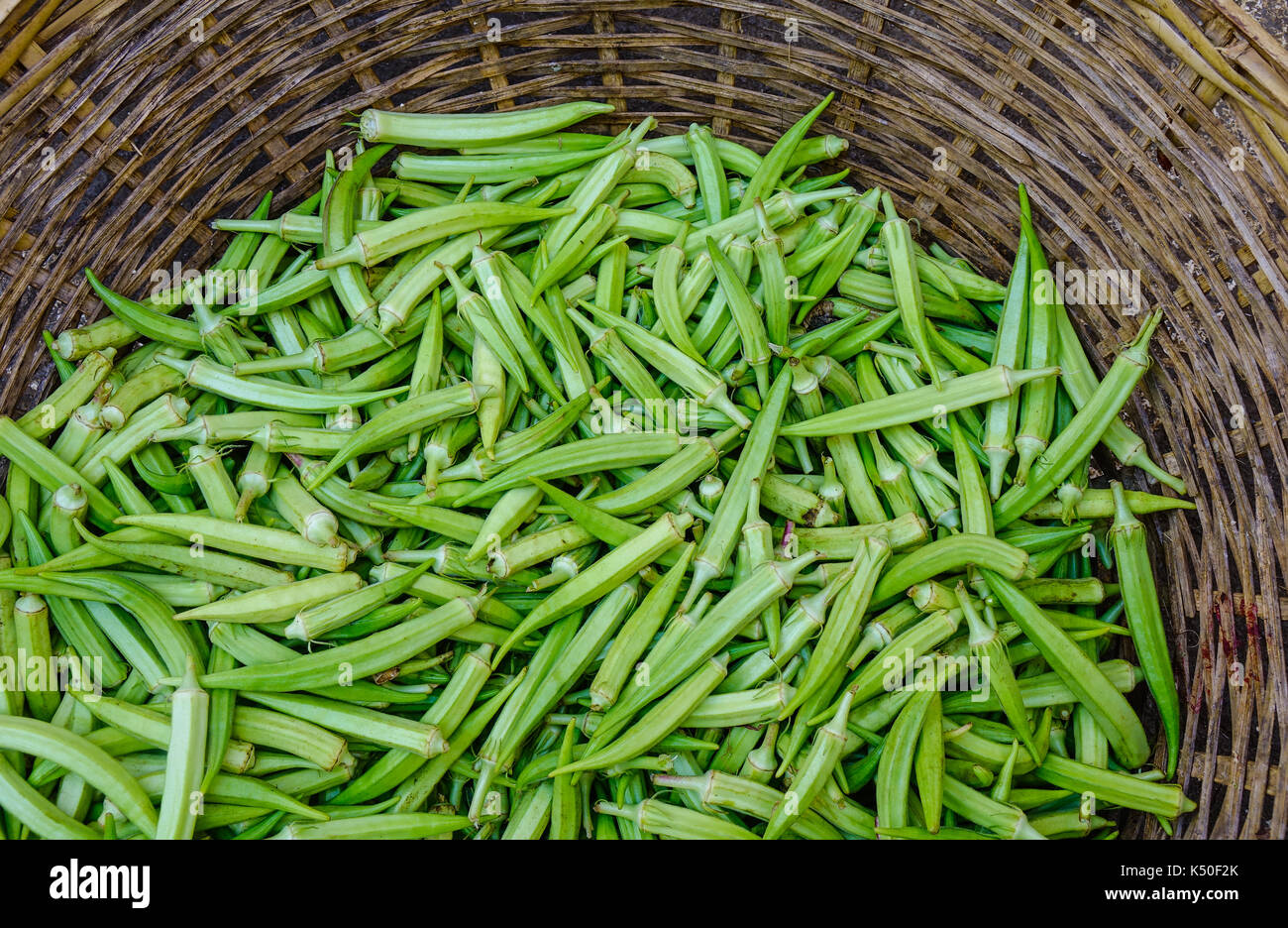 Fresh okra in bamboo basket at the farmer market in Mauritius Island ...