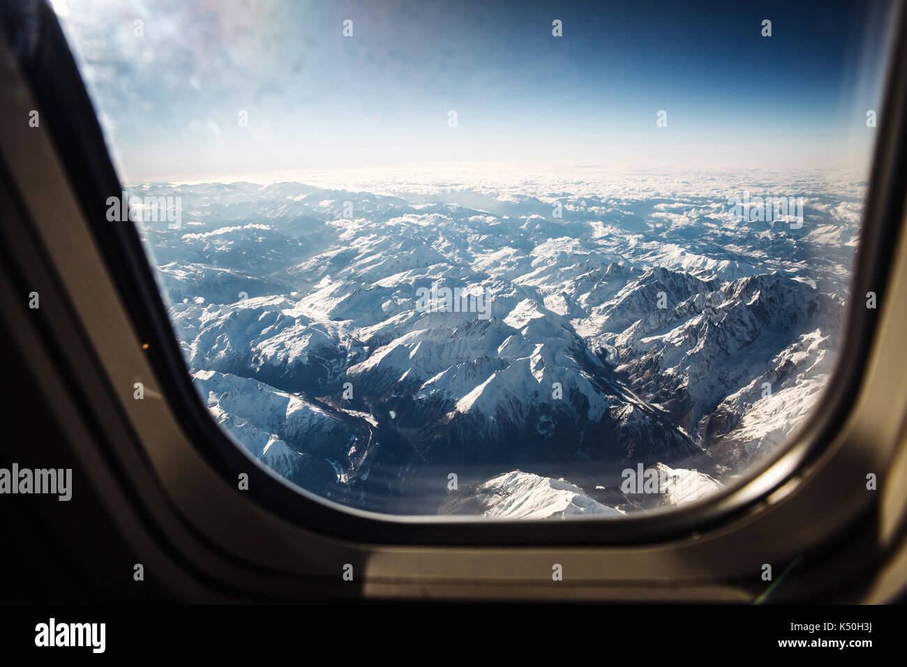 Breathtaking view of the Alps mountains from the airplane window Stock ...