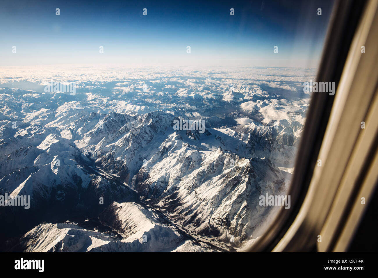 Breathtaking view of the Alps mountains from the airplane window Stock ...