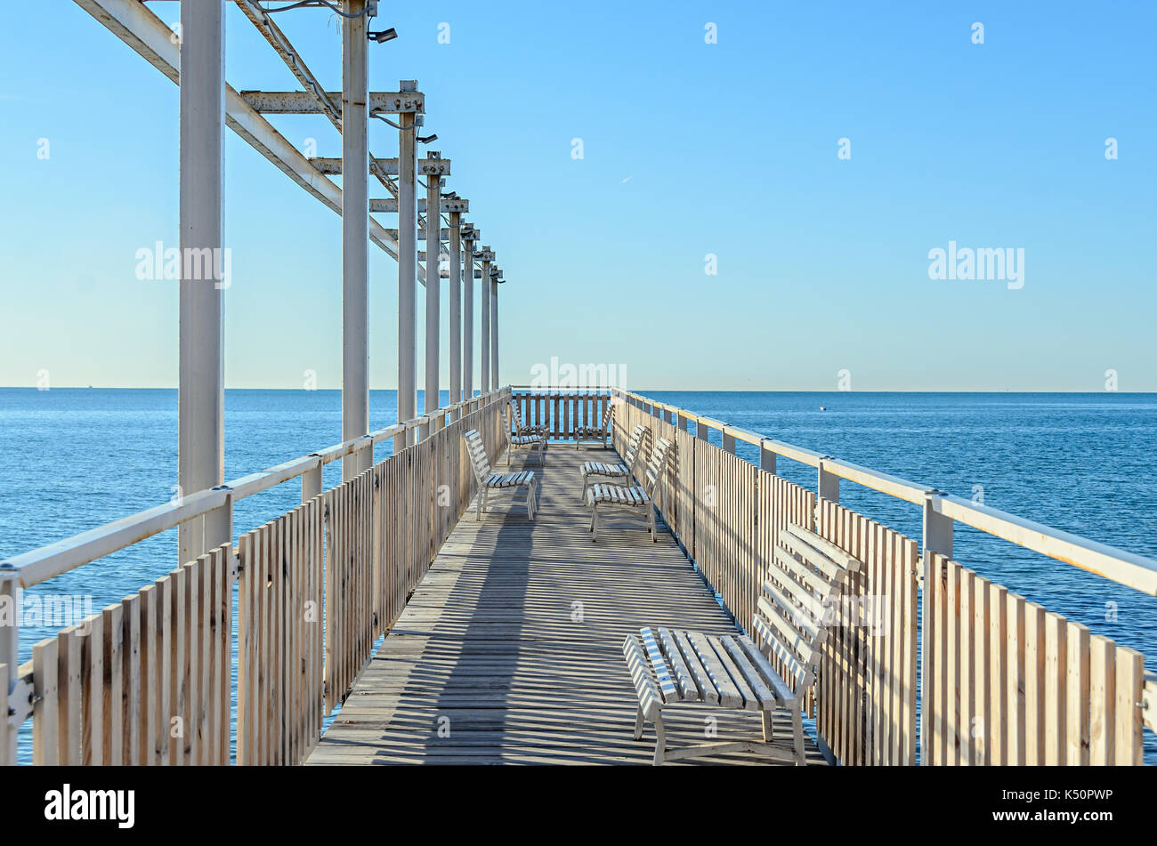 Seaside bridge with kissing points and benches on Black Sea, blue clear ...