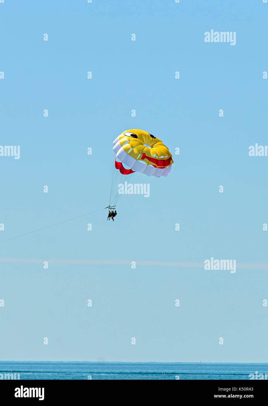 Colored parasail wing pulled by a boat in the sea water, Parasailing ...