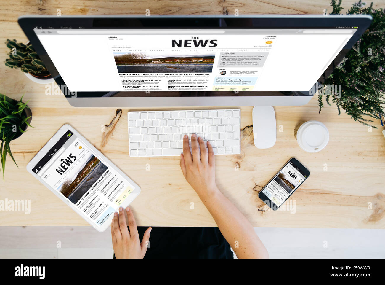 overhead desktop with news website on devices screen Stock Photo - Alamy