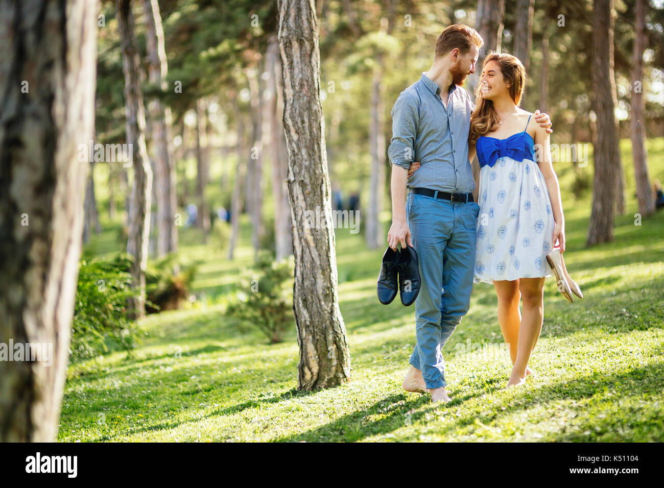 Romantic couple walking forest Stock Photo - Alamy