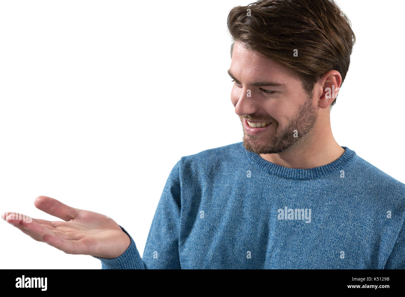 Man pretending to hold an invisible object against white background ...