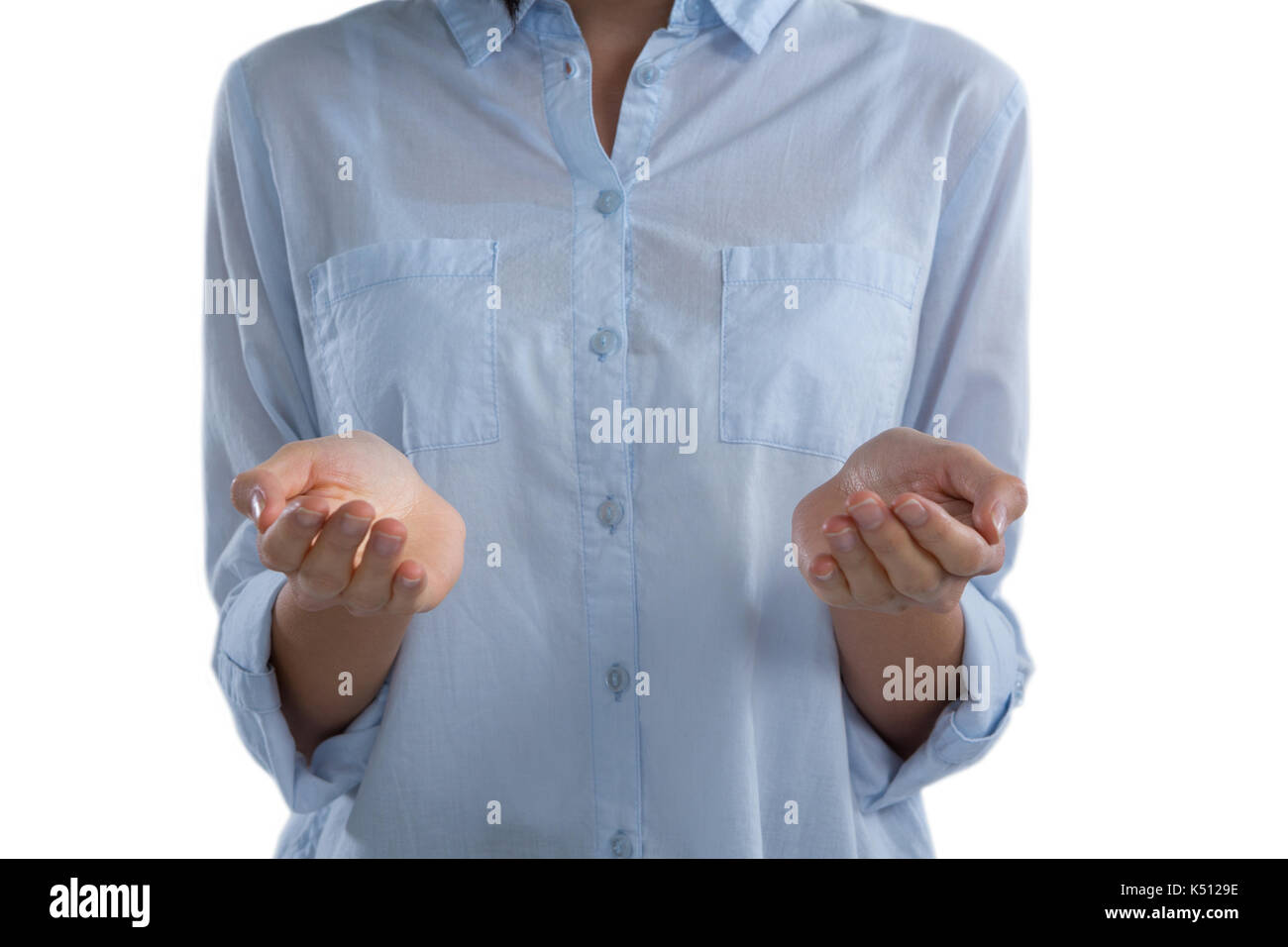 Mid-section of woman pretending to hold an invisible object against ...