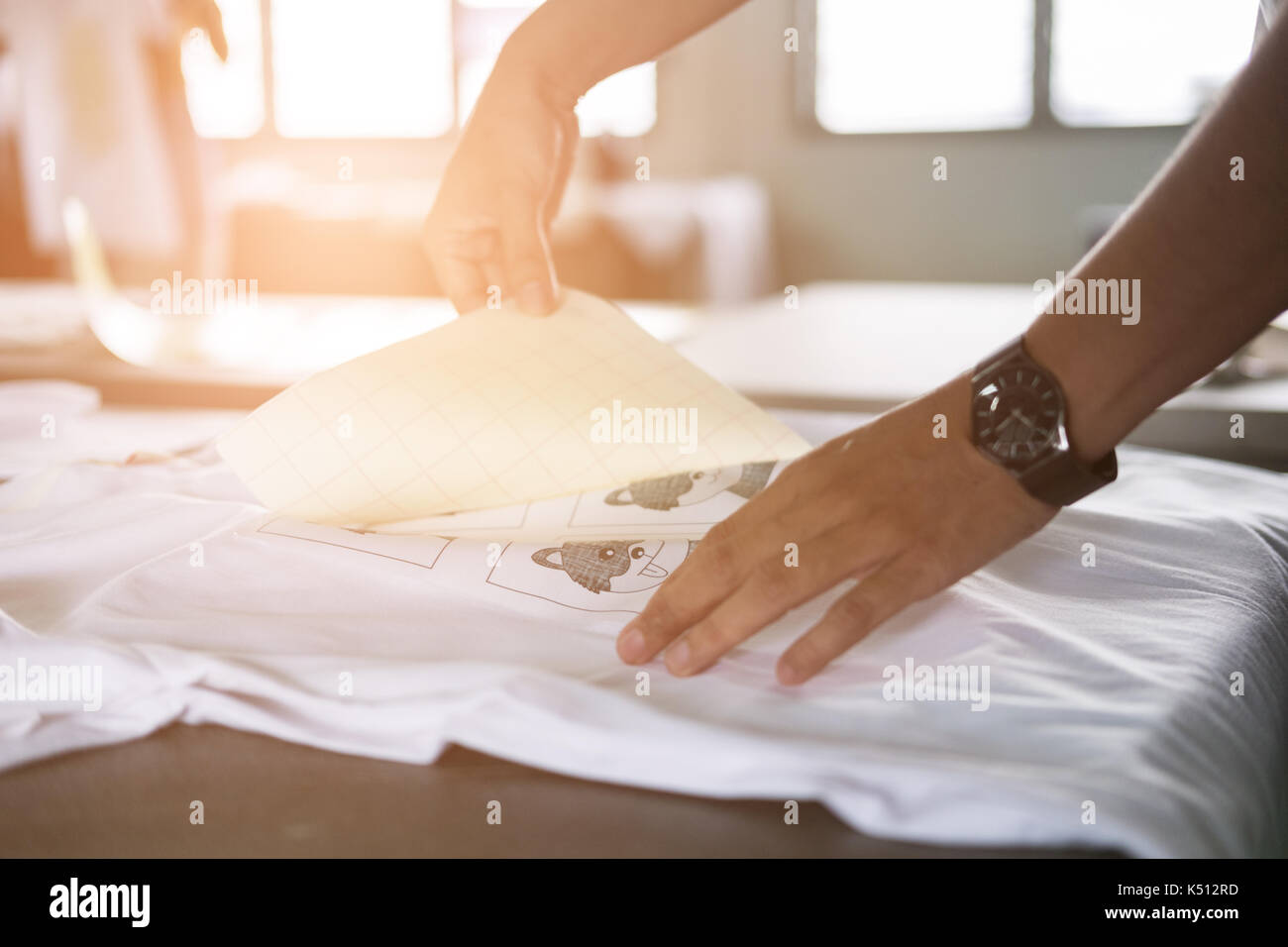 Young woman pull out paper from waterproof film on fabric. worker ...