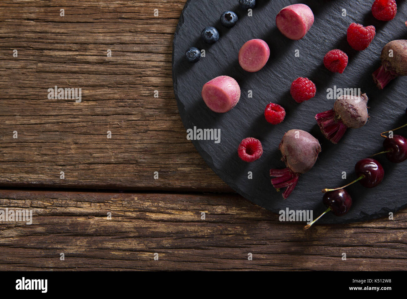Overhead view of fruits and vegetables on chopping board Stock Photo ...